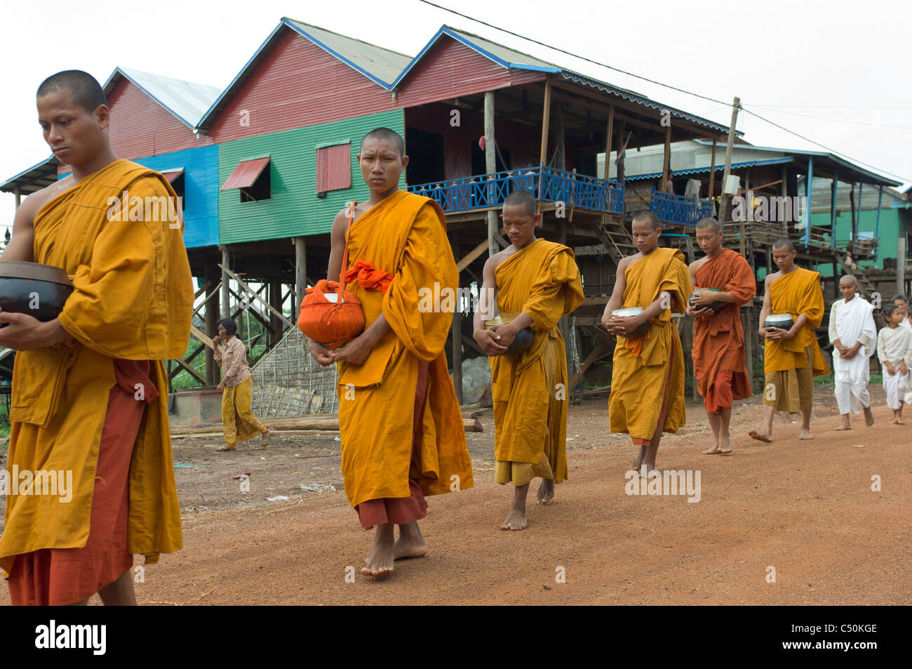 Buddhist monks and nuns on their morning alms round, Kompong Klang, on ...