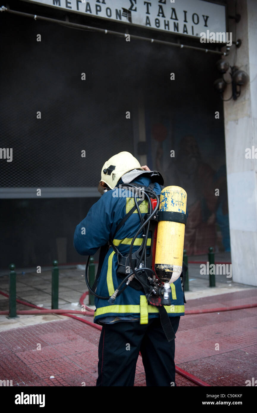 Firefighters trying to put off a fire in a bank in Panepistimiou street ...