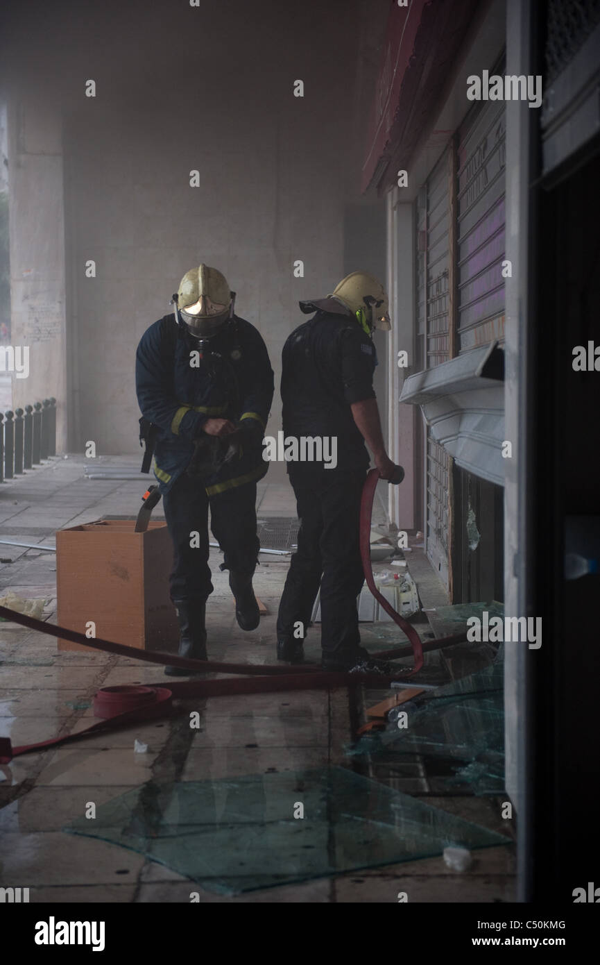 Firefighters trying to put off a fire in a bank in Panepistimiou street ...