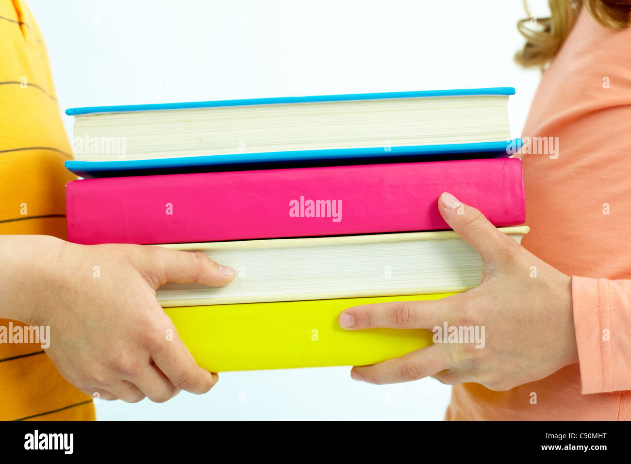 Close-up of childish hand giving books to classmate Stock Photo - Alamy