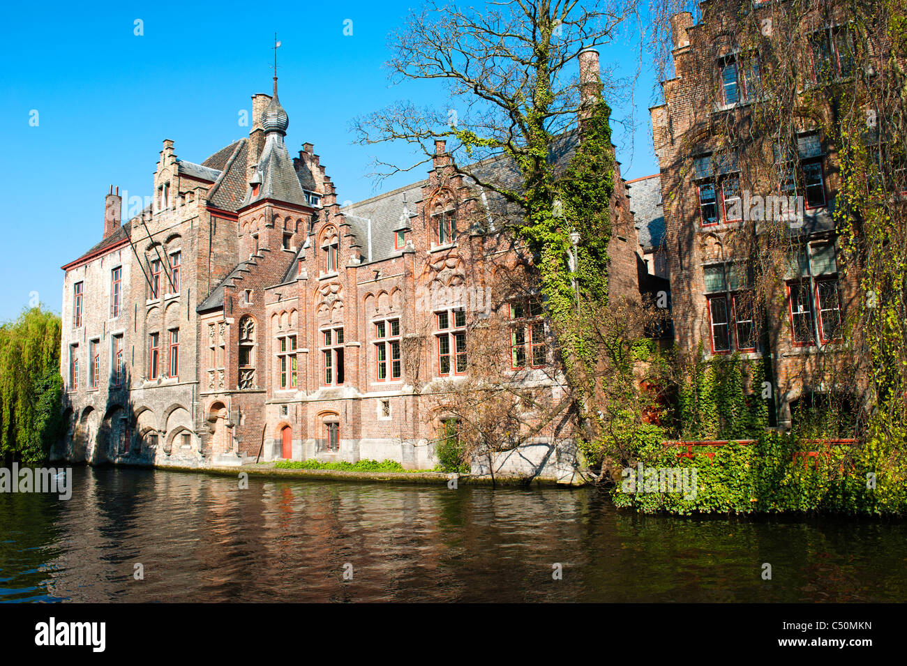 Buildings along a canal, Historic centre of Bruges, Belgium Stock Photo ...