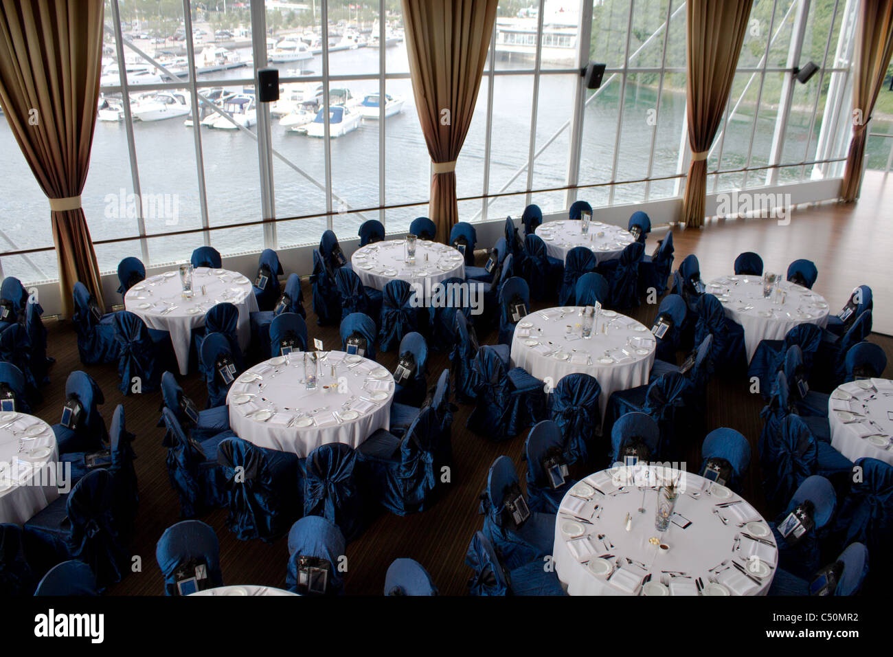 banquet hall empty tables tall windows natural light Stock Photo - Alamy