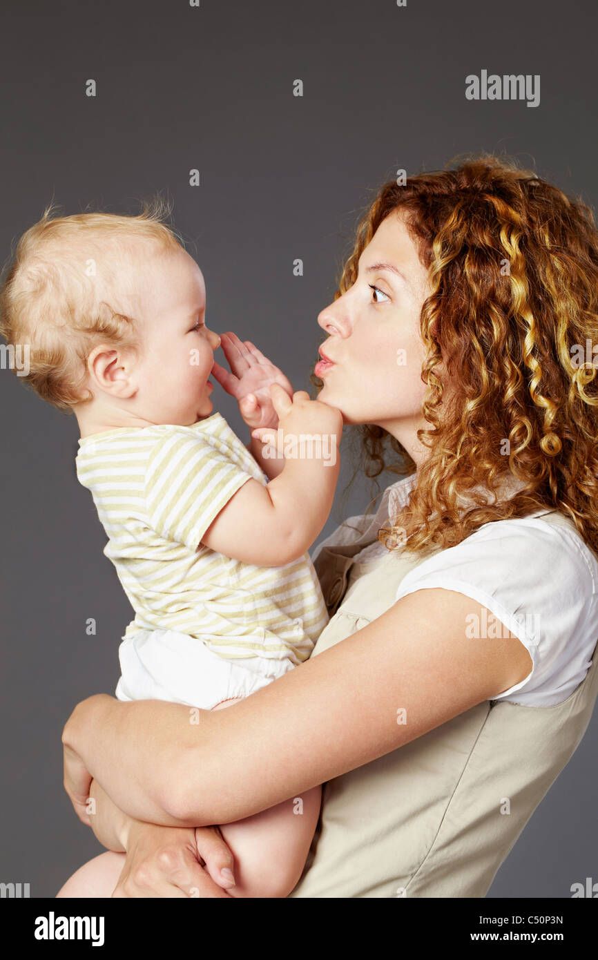 Portrait of happy woman making fun with her baby Stock Photo - Alamy