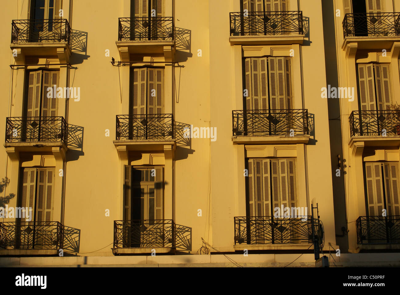 Traditional ironwork balconies and wood shutters Stock Photo - Alamy