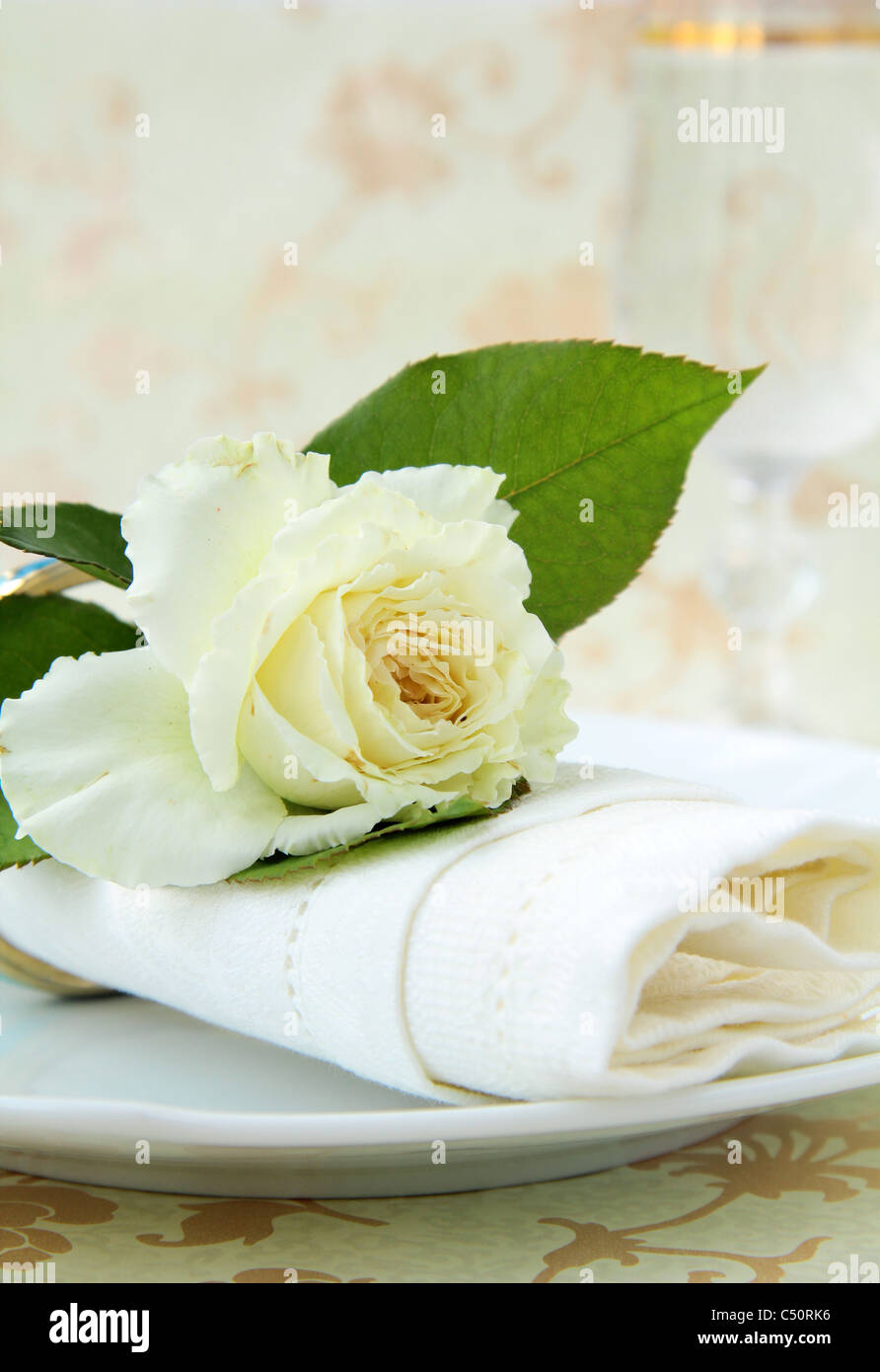 wedding table setting with a white rose Stock Photo - Alamy