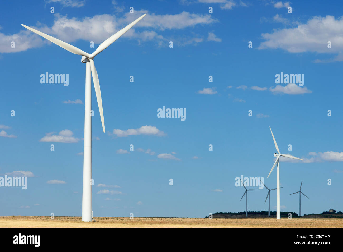 group of windmills with cloudy sky Stock Photo - Alamy
