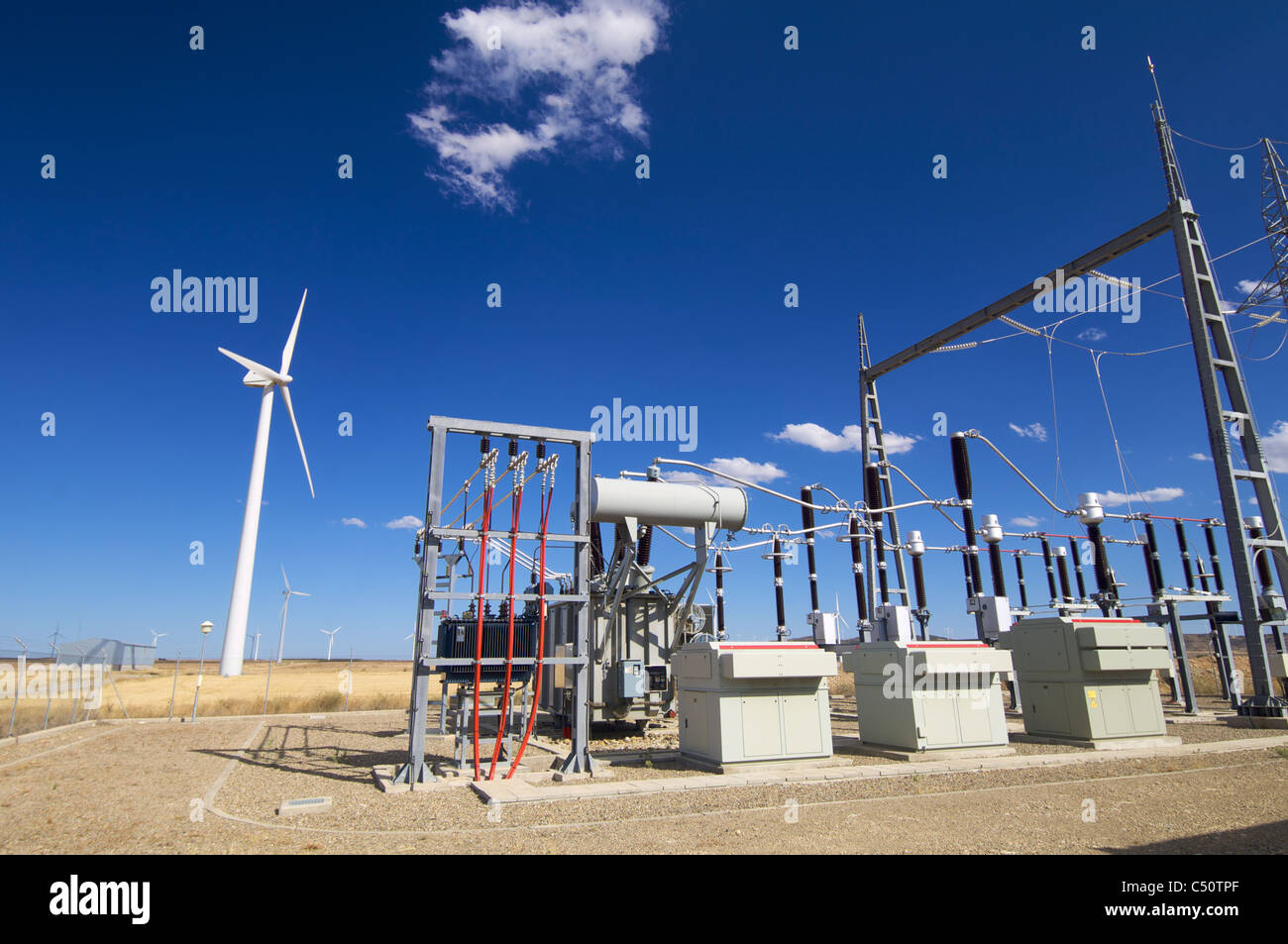 high-voltage substation and windmill with blue sky in Spain Stock Photo ...