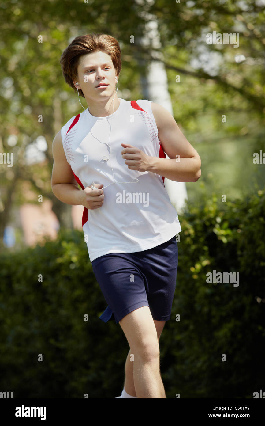 Portrait of a young man jogging with a walkman Stock Photo - Alamy