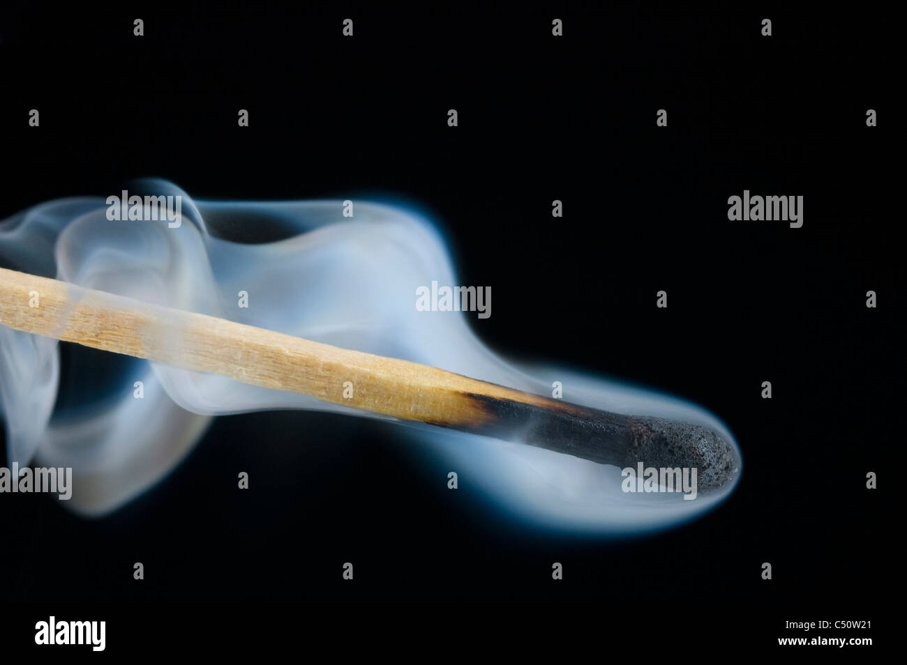 An ordinary household safety match - smoking, on black Stock Photo - Alamy