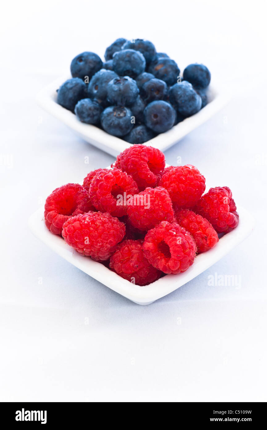 Together blueberries and raspberries on white background Stock Photo ...