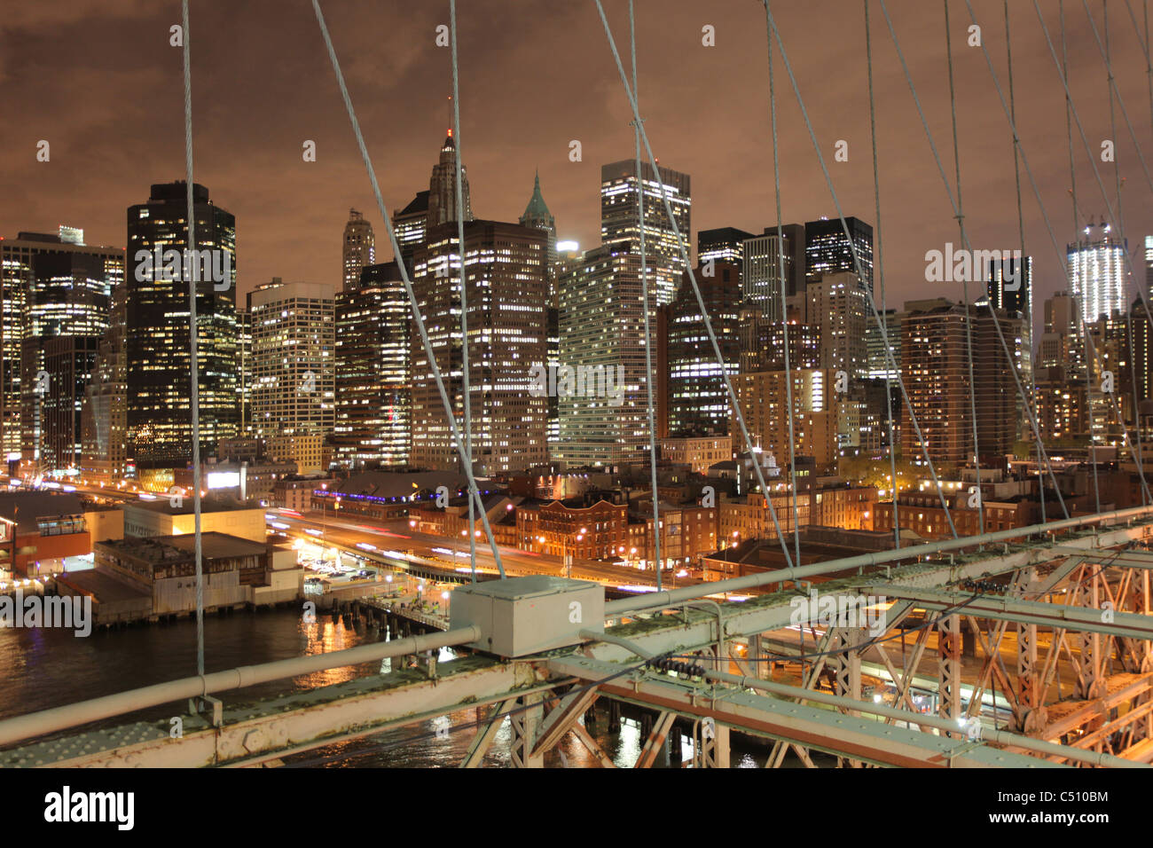 shot of lower manhattan from brooklyn bridge at night Stock Photo - Alamy