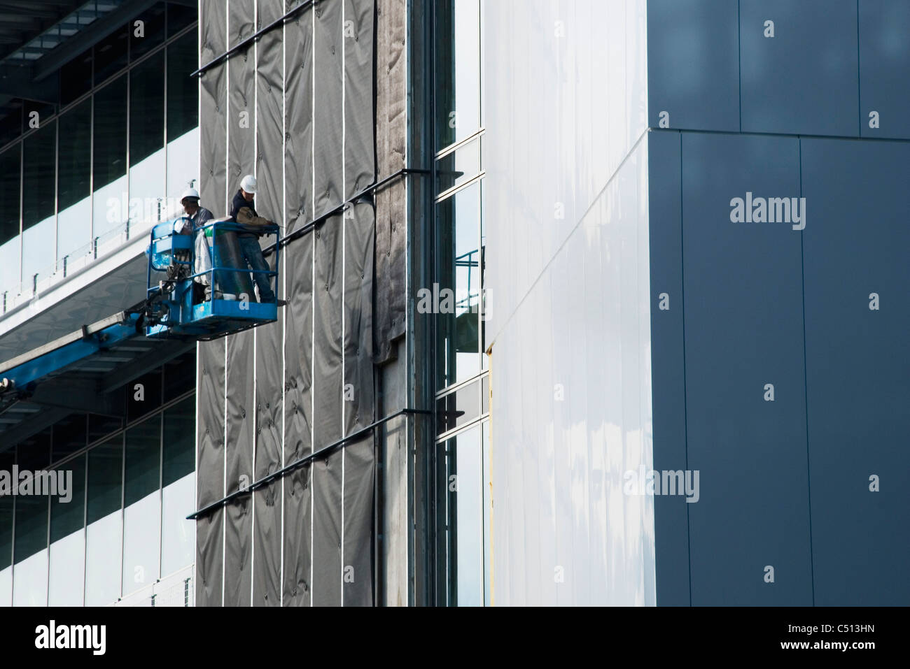 Construction workers in cherry picker Stock Photo - Alamy