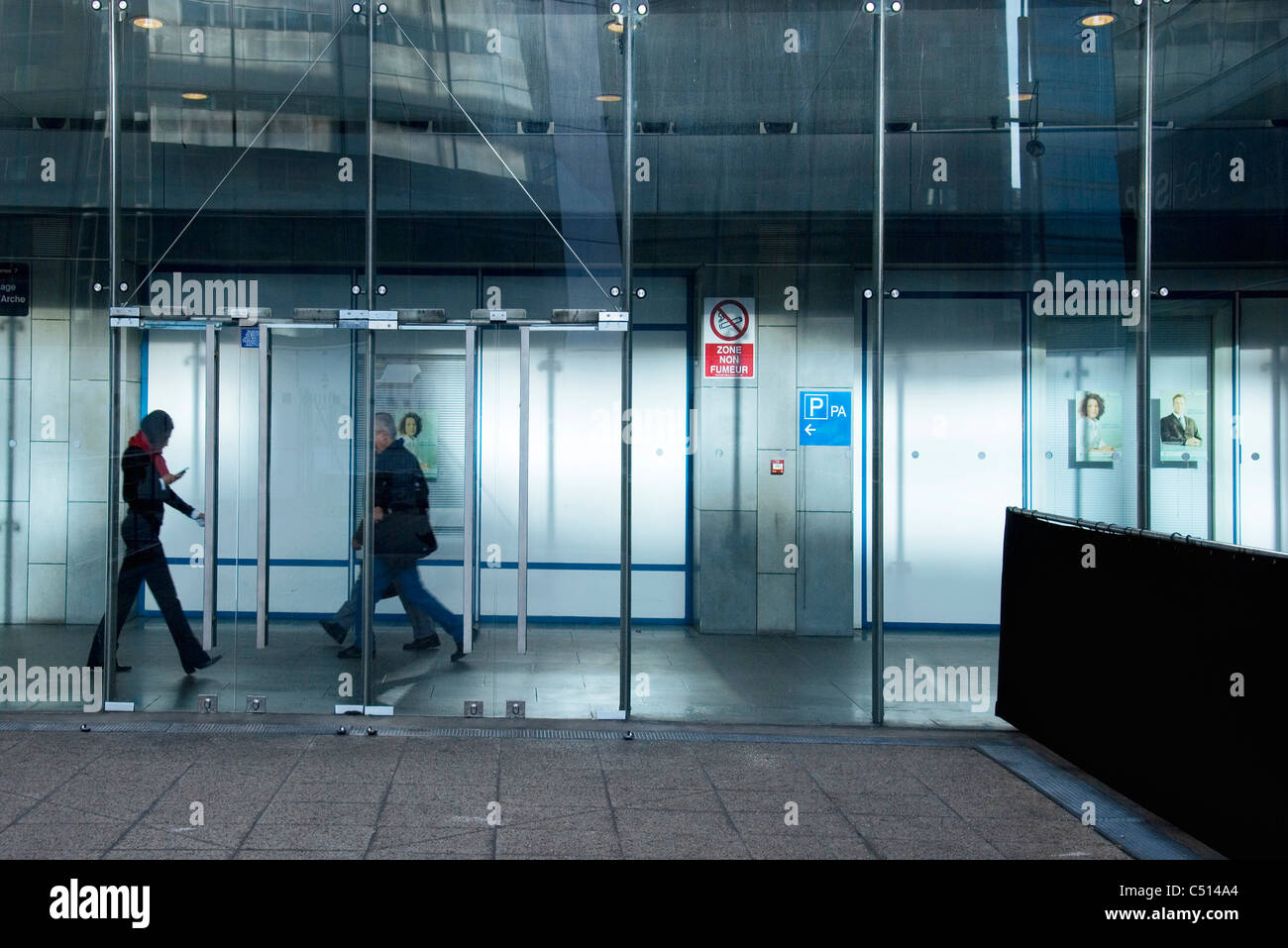 People walking behind glass entrance Stock Photo - Alamy