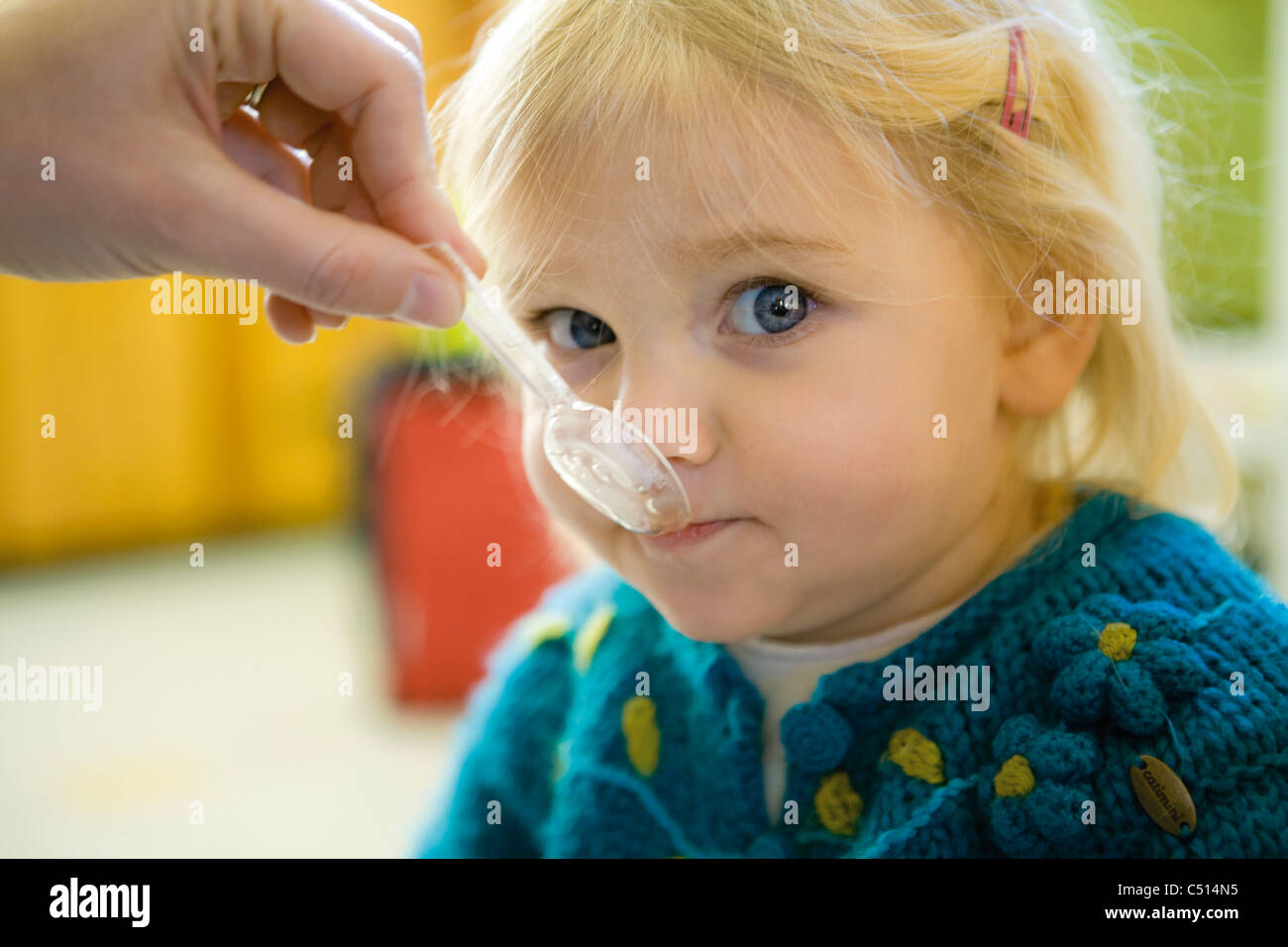 Baby girl being fed snack, cropped Stock Photo - Alamy