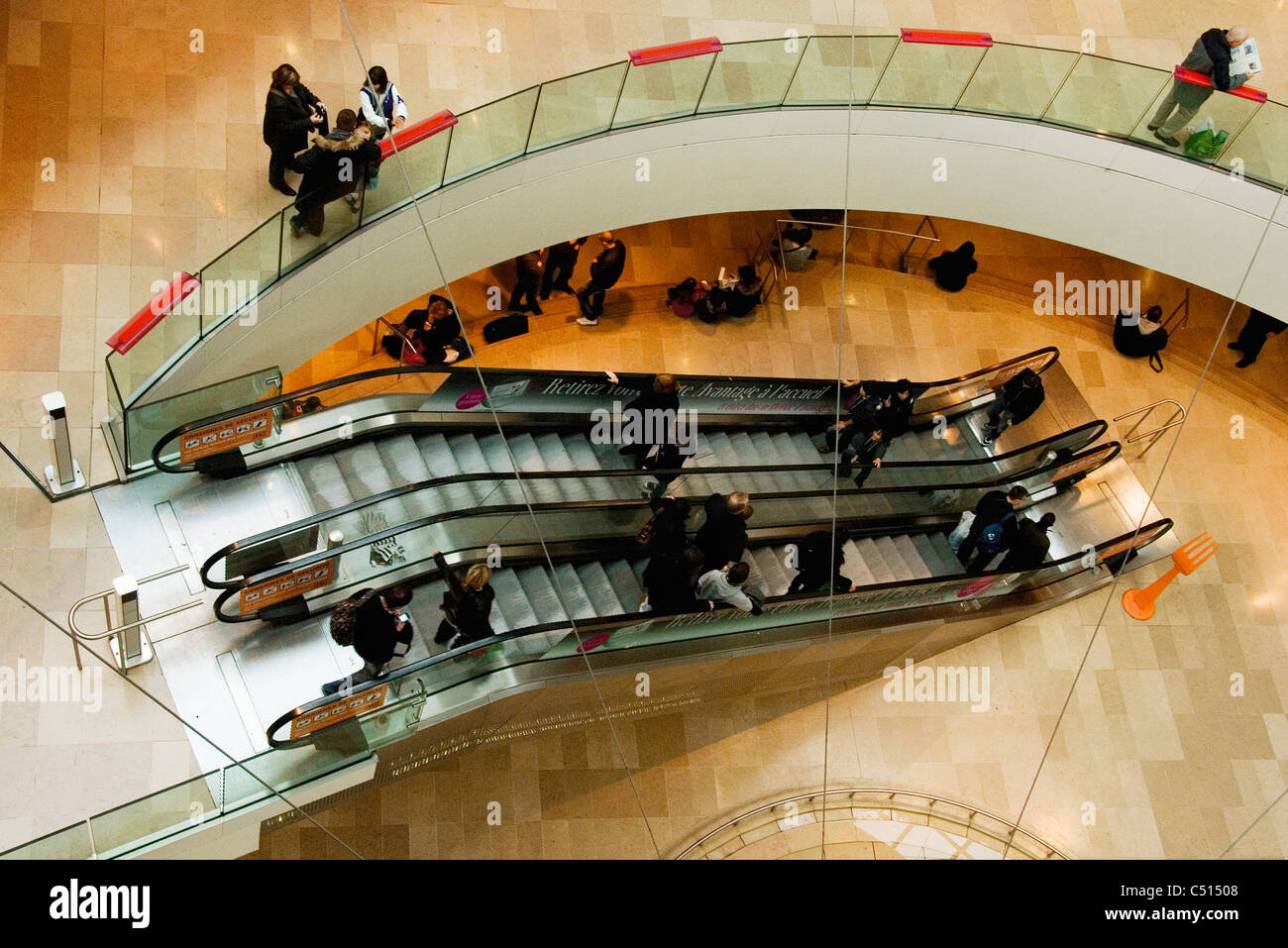 People riding escalators in shopping mall Stock Photo - Alamy
