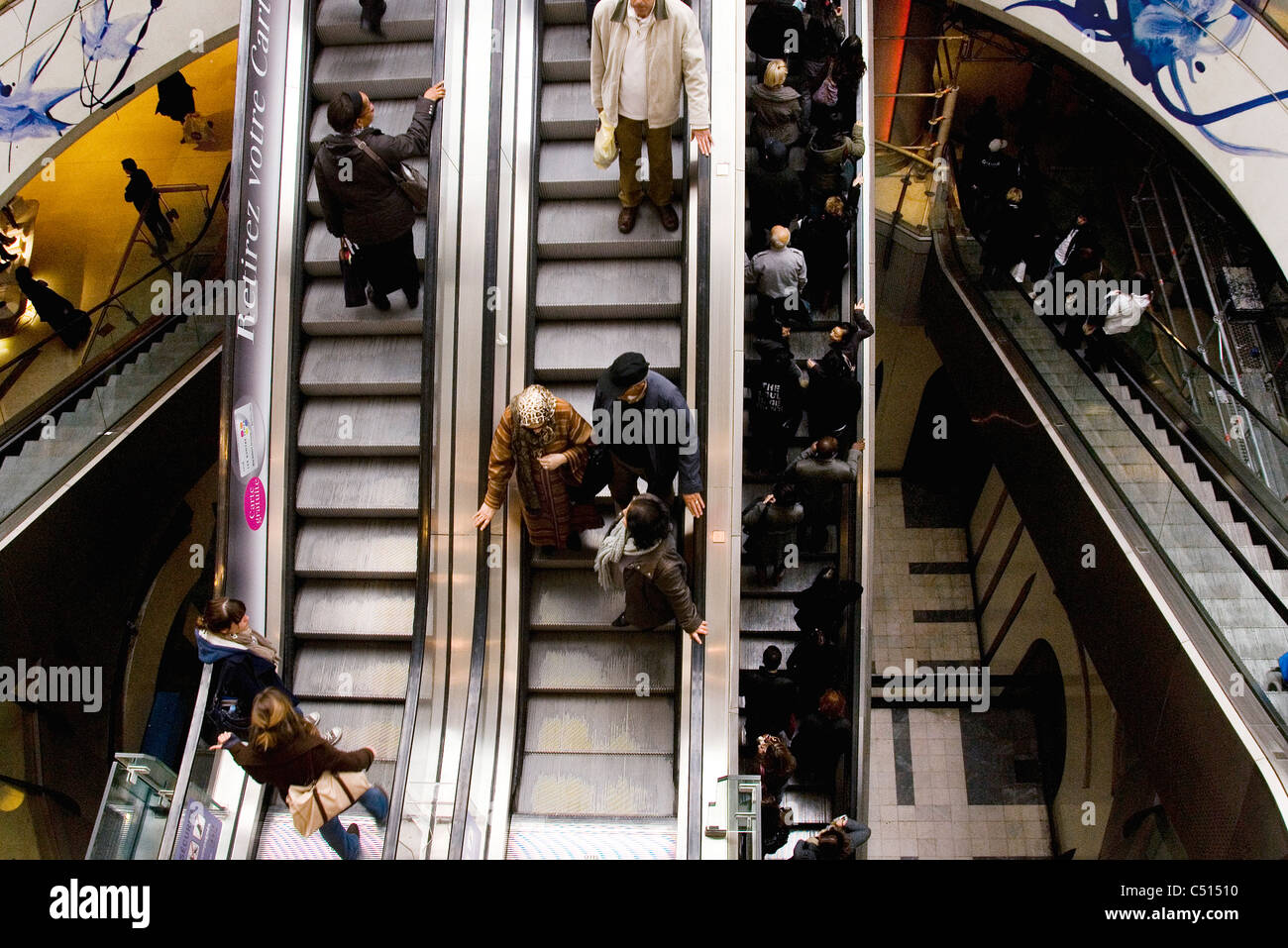People riding escalators Stock Photo - Alamy