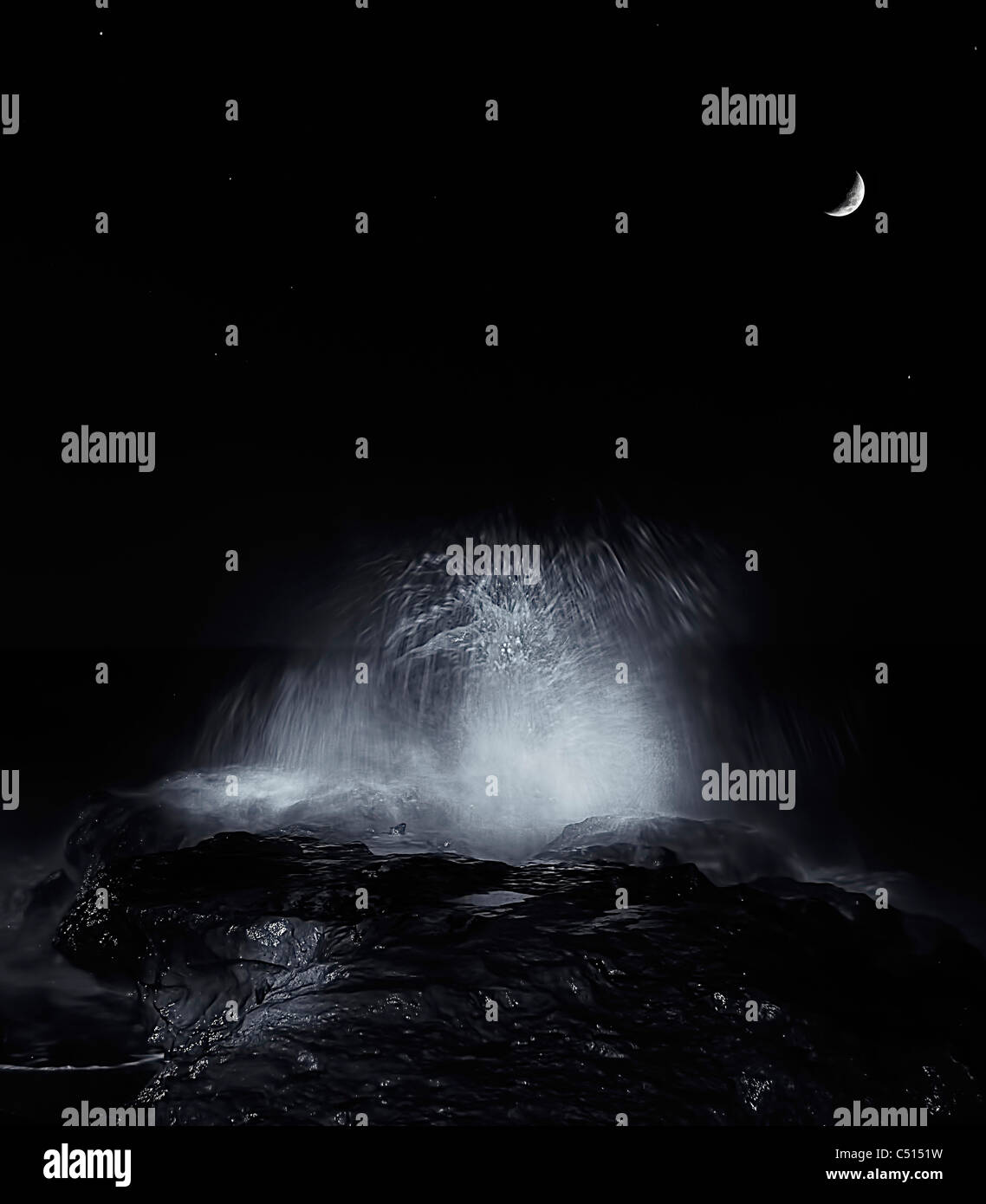 The crescent moon and waves splashing over rocks in Miramar, Argentina ...