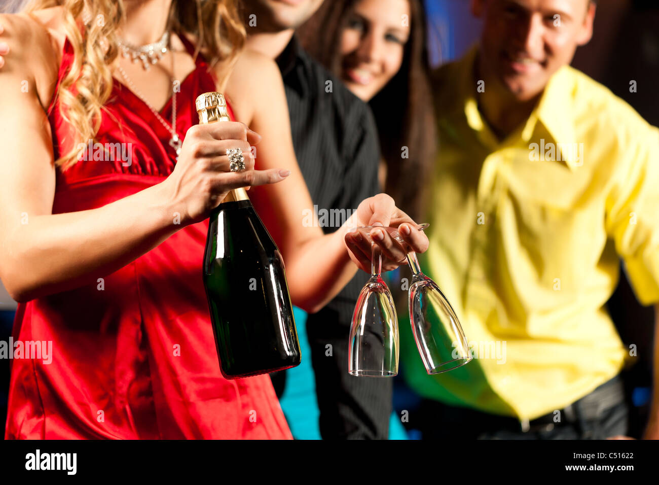 Group of party people with champagne in a bar or club having fun Stock ...