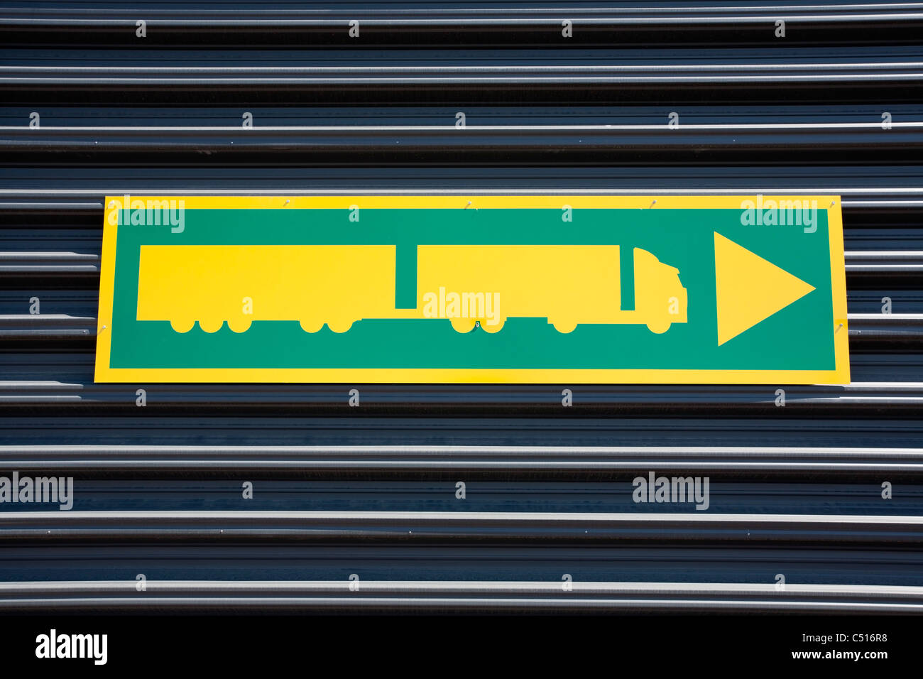 truck guidance sign on warehouse wall Stock Photo - Alamy