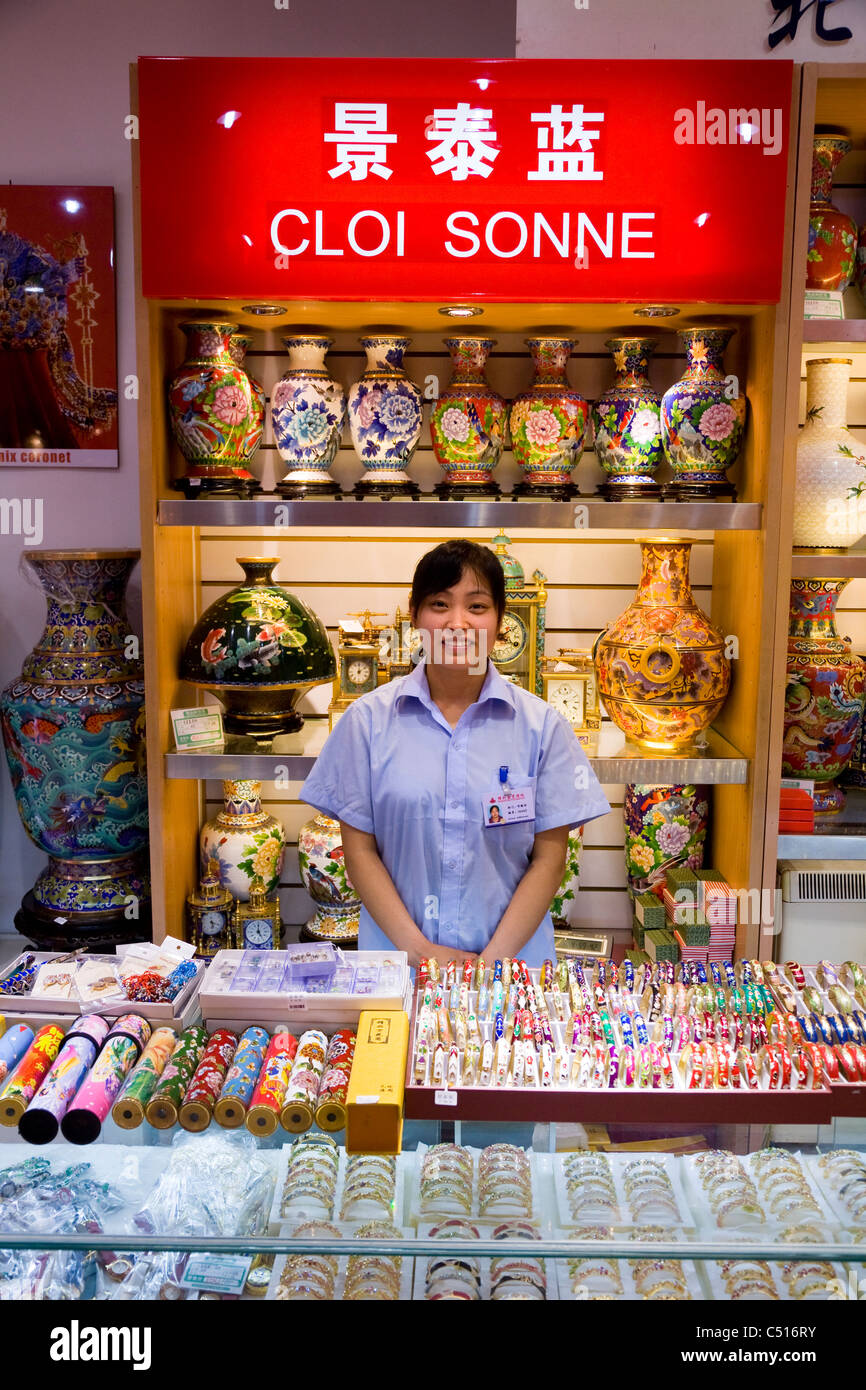 Adult woman / female / girl shop assistant with display & counter. The ...