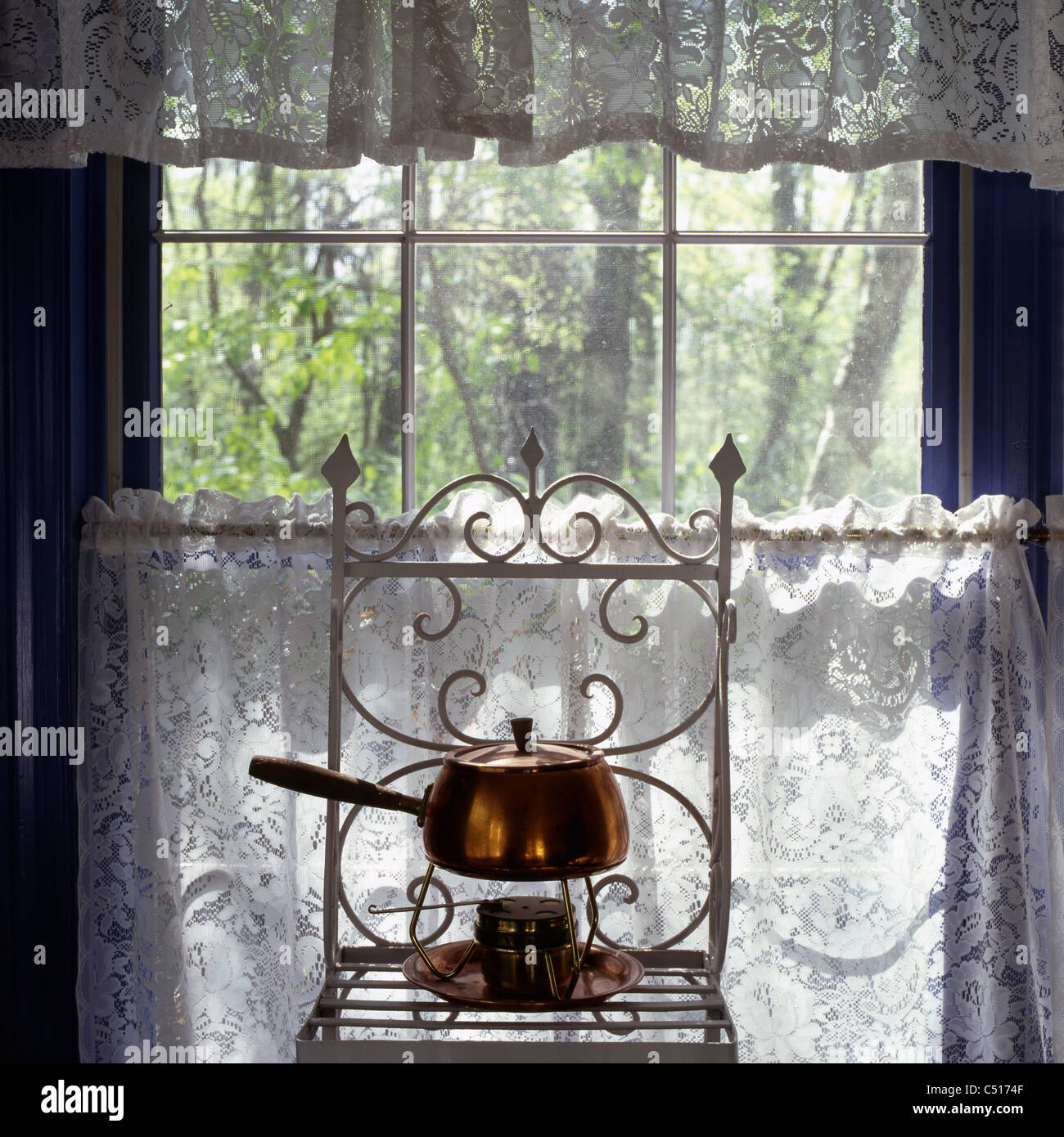 Old-fashioned pan on shelf in front of window Stock Photo - Alamy