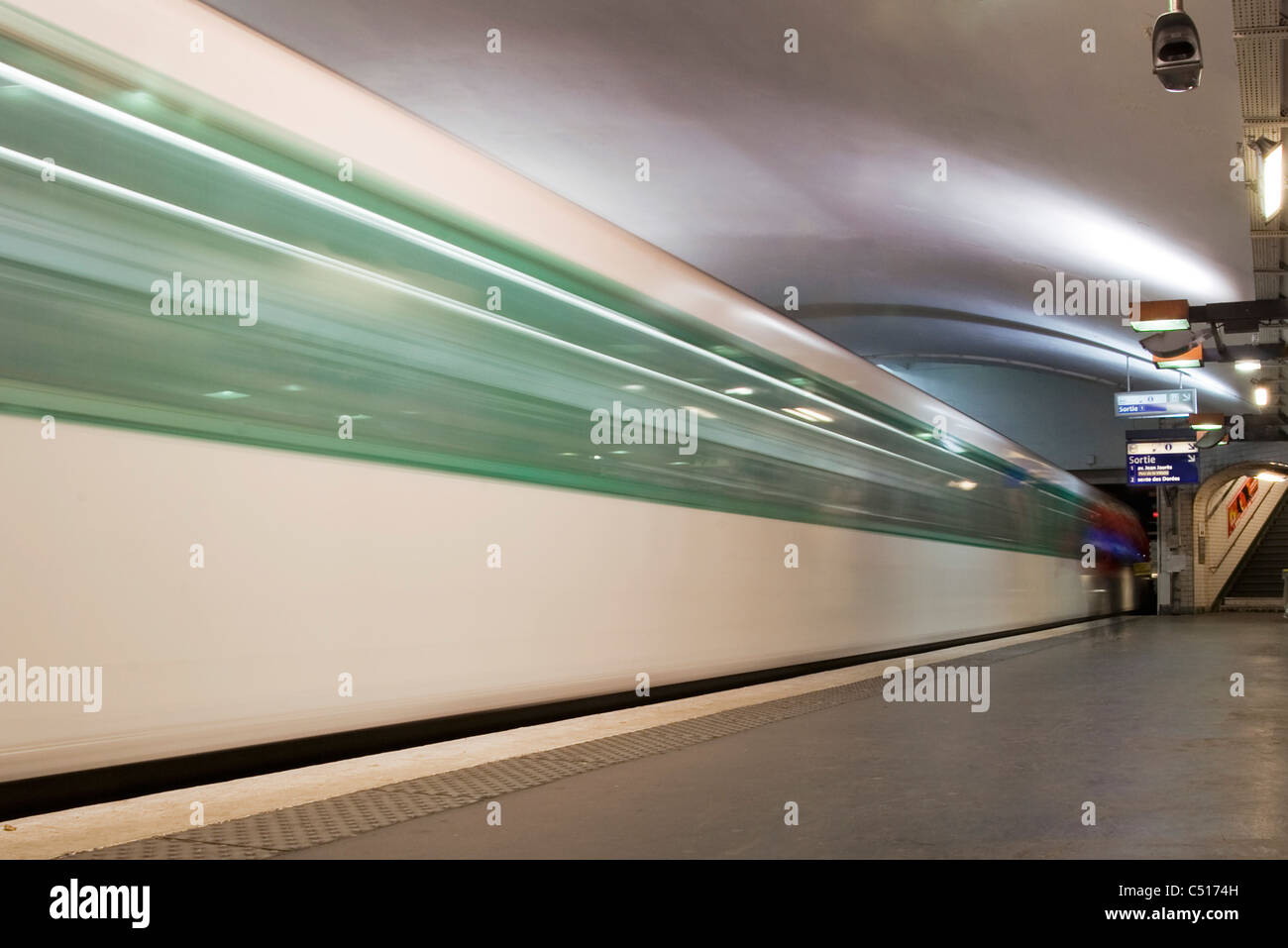 Subway train passing through underground station Stock Photo - Alamy