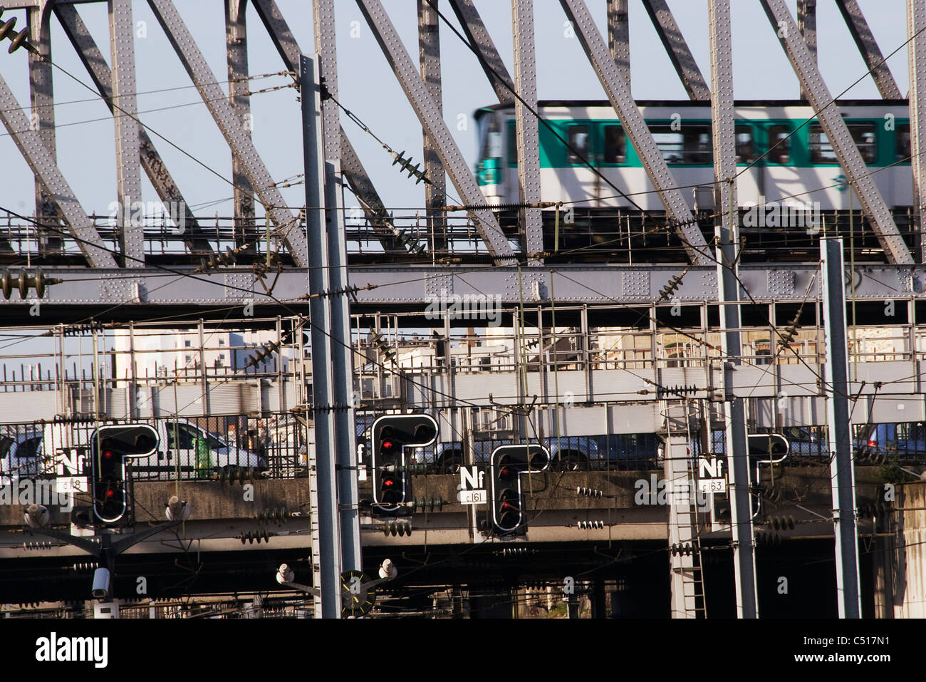 Subway train passing on bridge over city traffic Stock Photo - Alamy