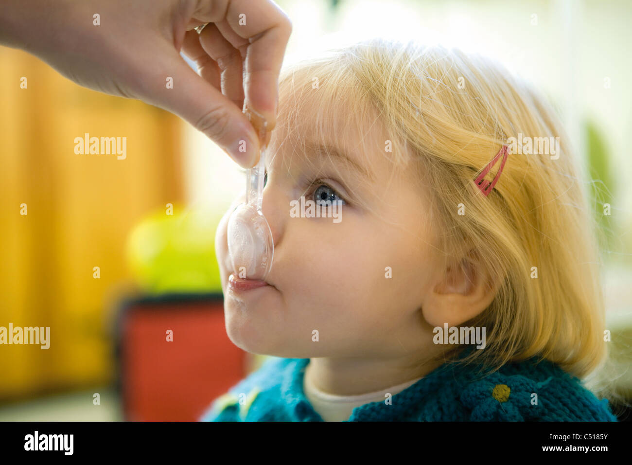 Baby girl being fed snack, cropped Stock Photo - Alamy