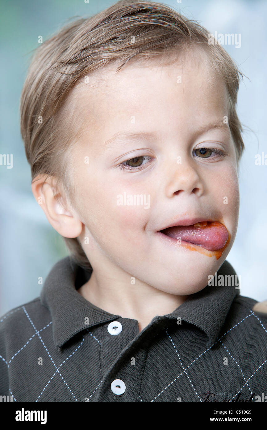 headshot of young boy licking lips Stock Photo - Alamy