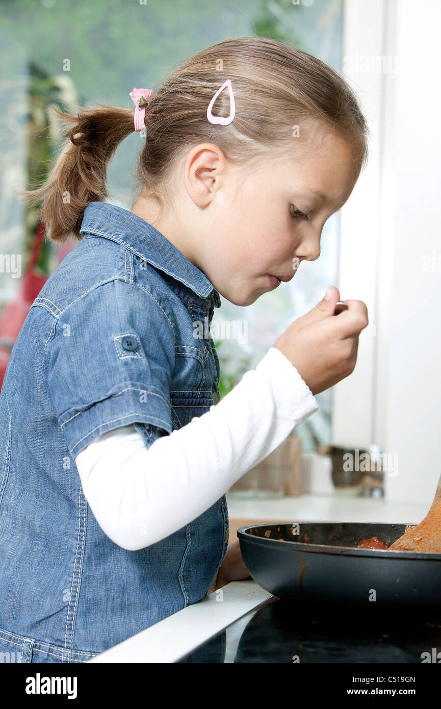 portrait of young girl cooking in kitchen Stock Photo - Alamy