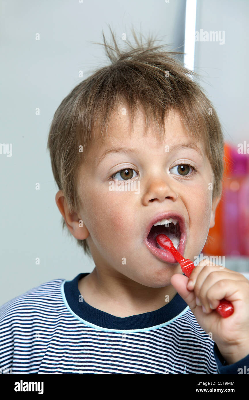 portrait of young boy brushing his teeth Stock Photo - Alamy