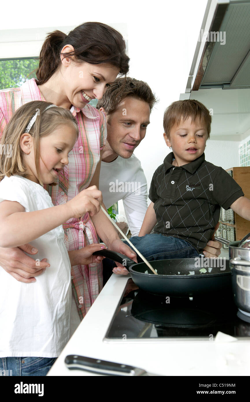 family cooking together in kitchen Stock Photo - Alamy
