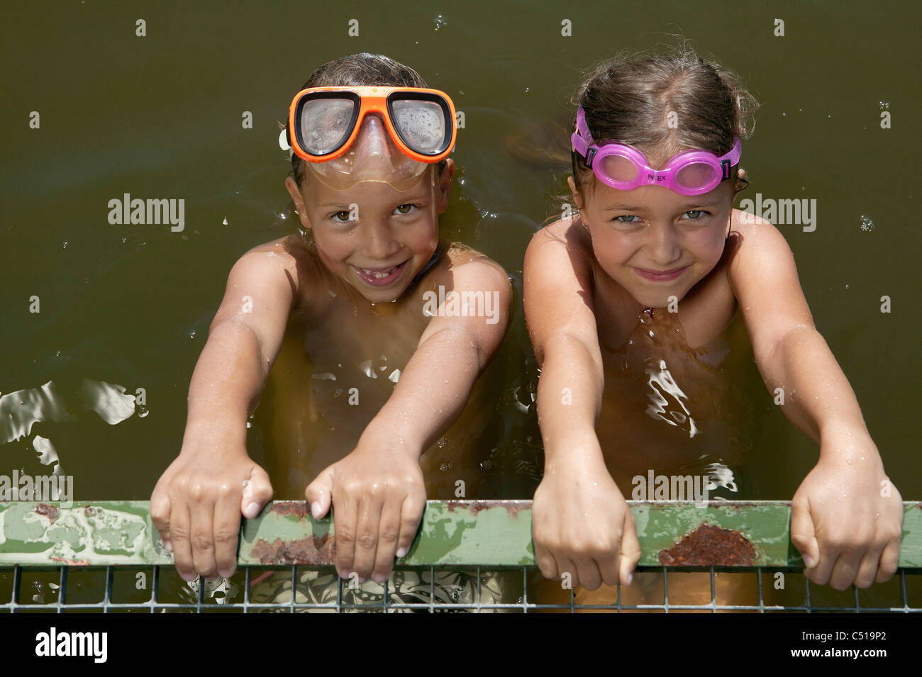 portrait of two girls swimming in lake Stock Photo - Alamy