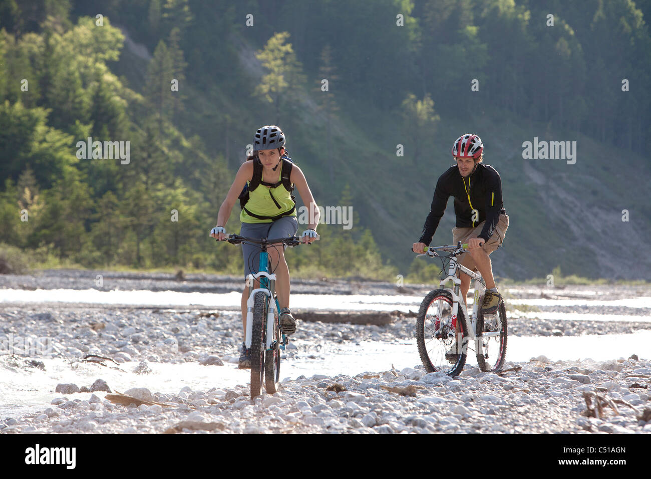 young couple cycling through nature Stock Photo - Alamy