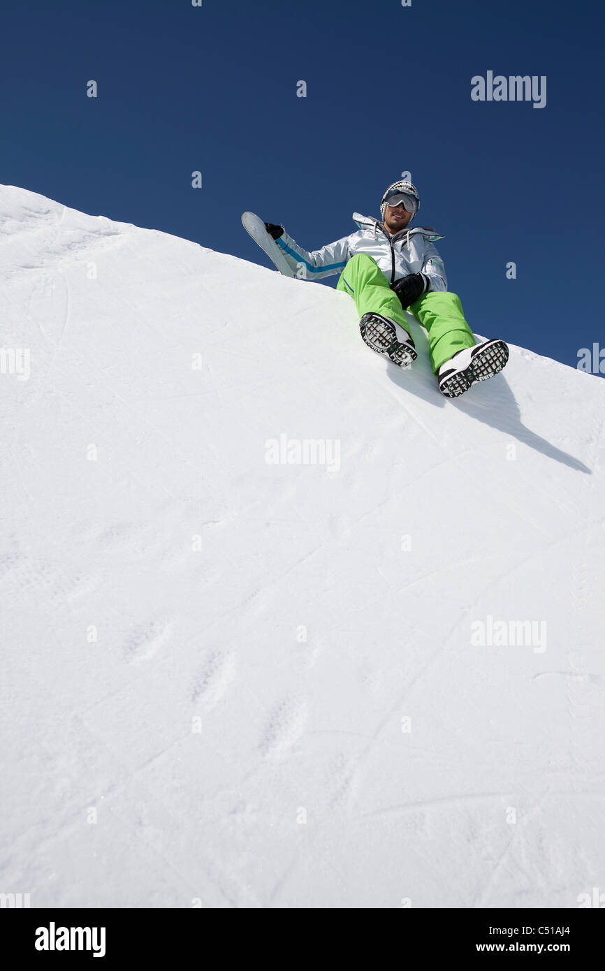 male skier sitting on snow Stock Photo - Alamy