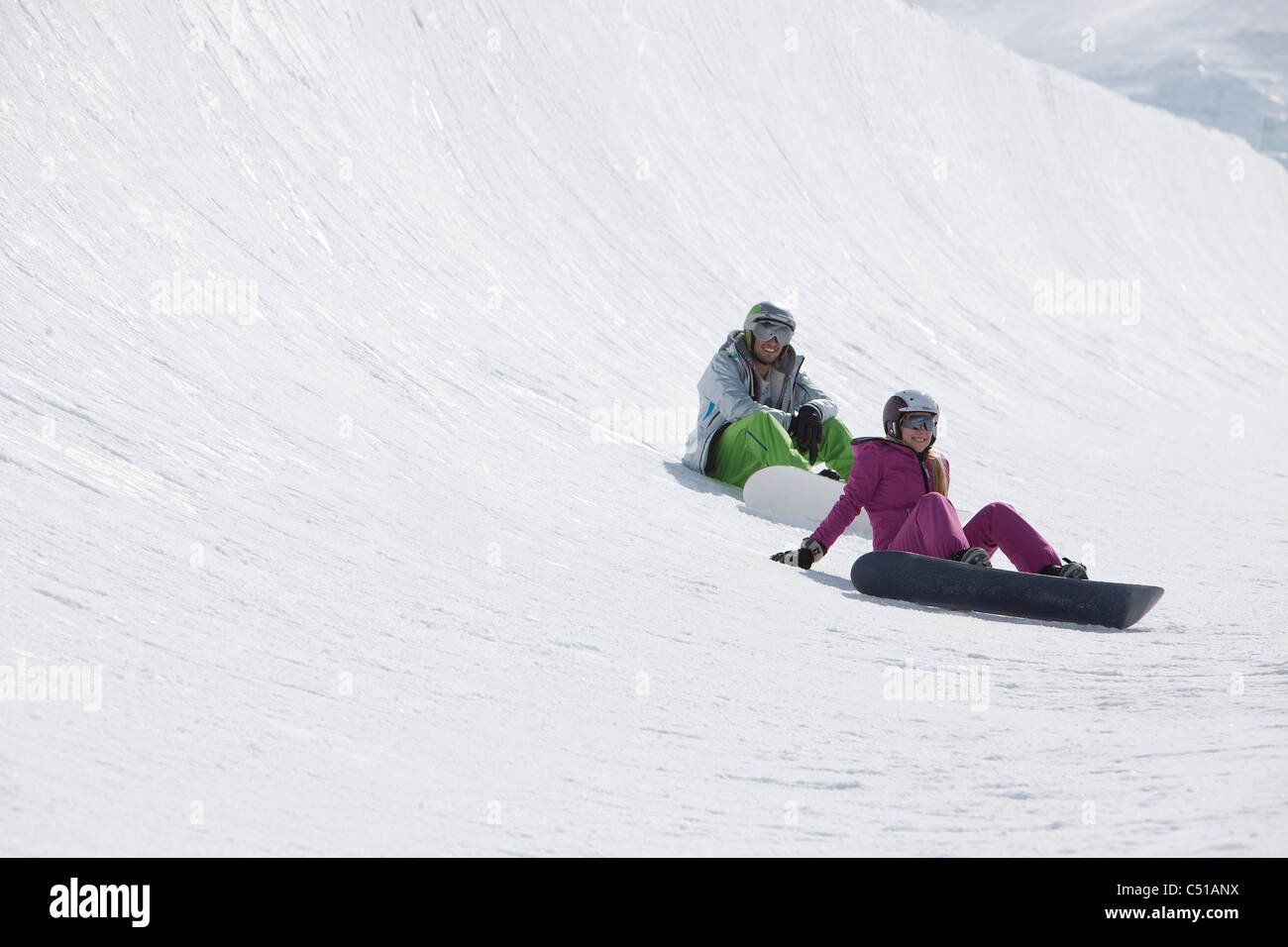young couple snowboarding in the mountains Stock Photo - Alamy