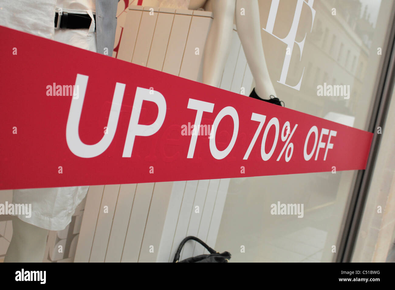 Sale sign in shop window Stock Photo - Alamy