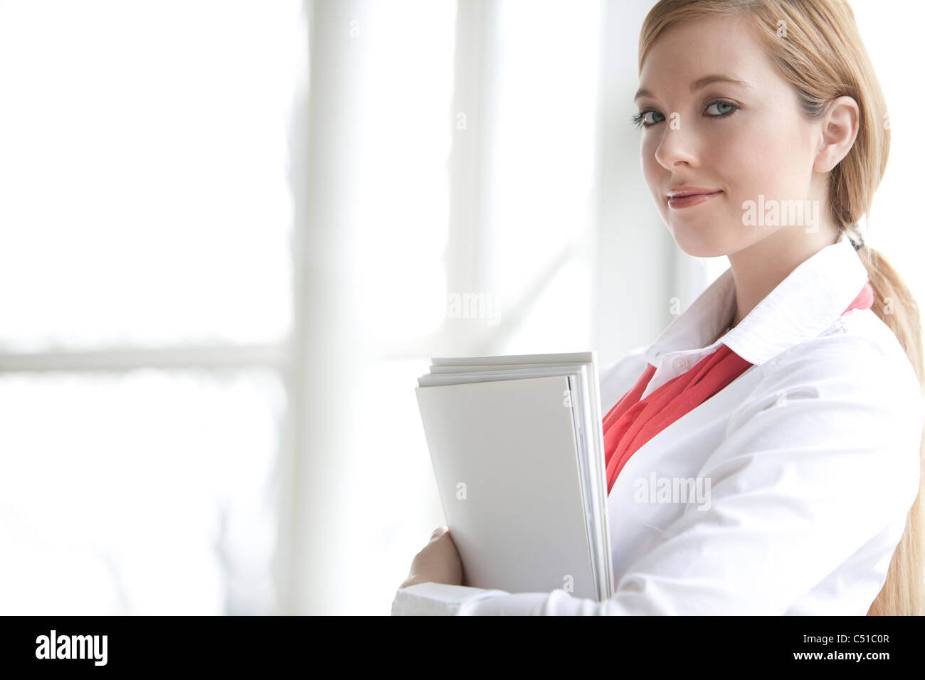 portrait of young businesswoman with document Stock Photo - Alamy