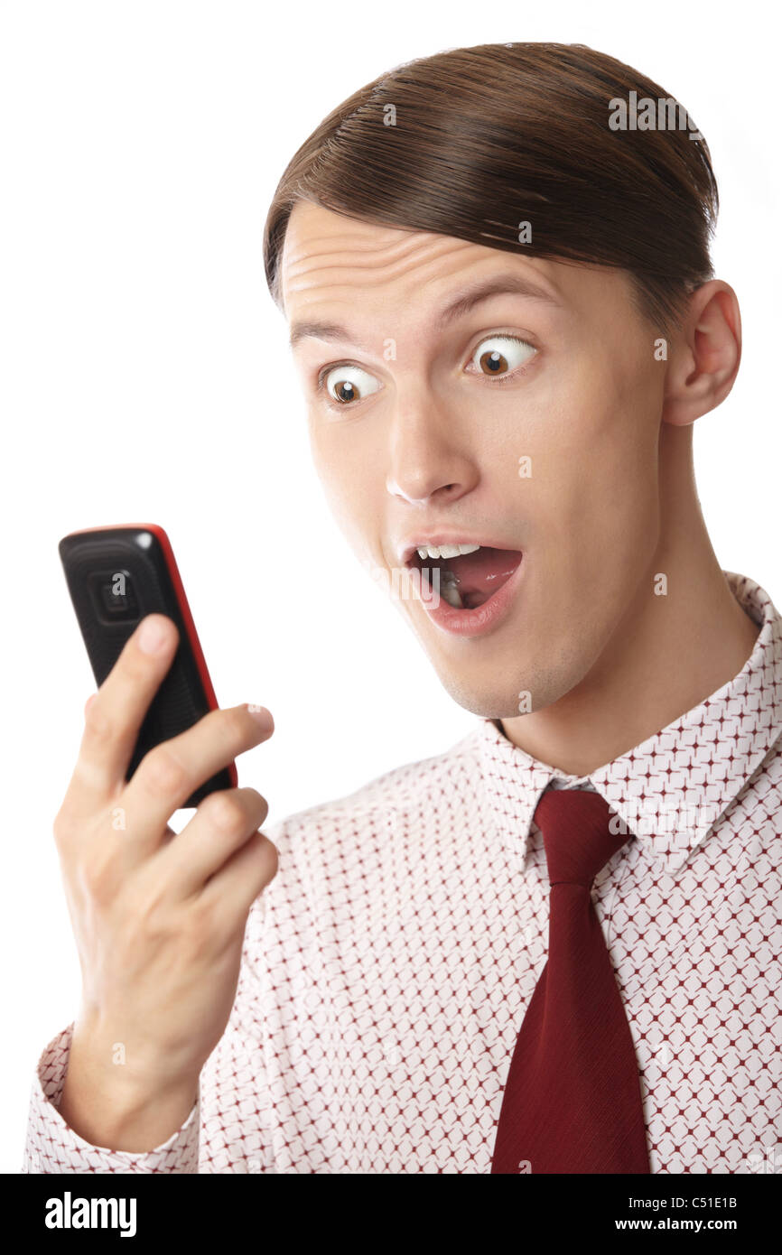 Emotional astonished businessman holding cell phone on a white ...