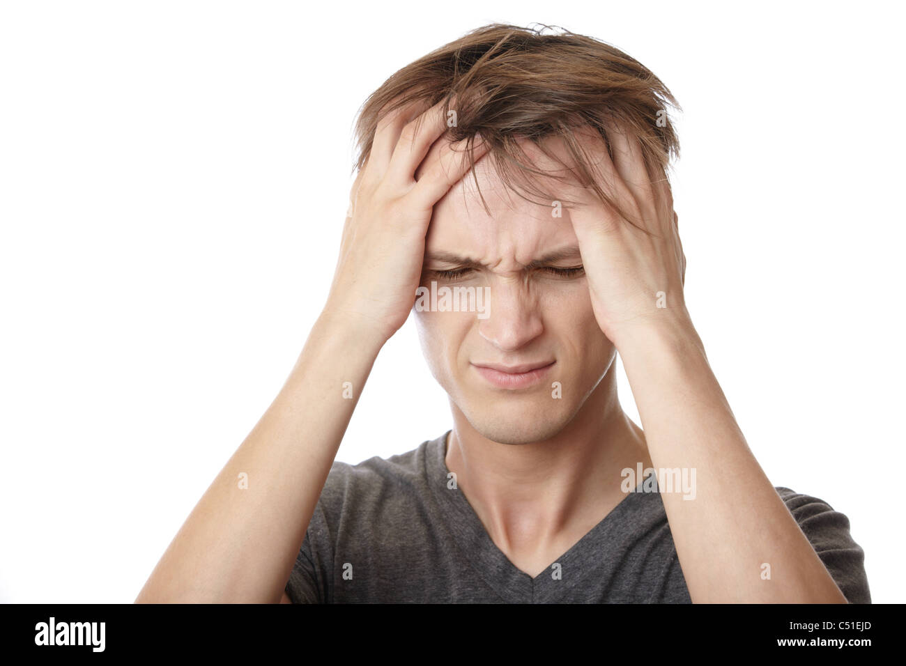Young man feeling emotional stress and headache Stock Photo - Alamy