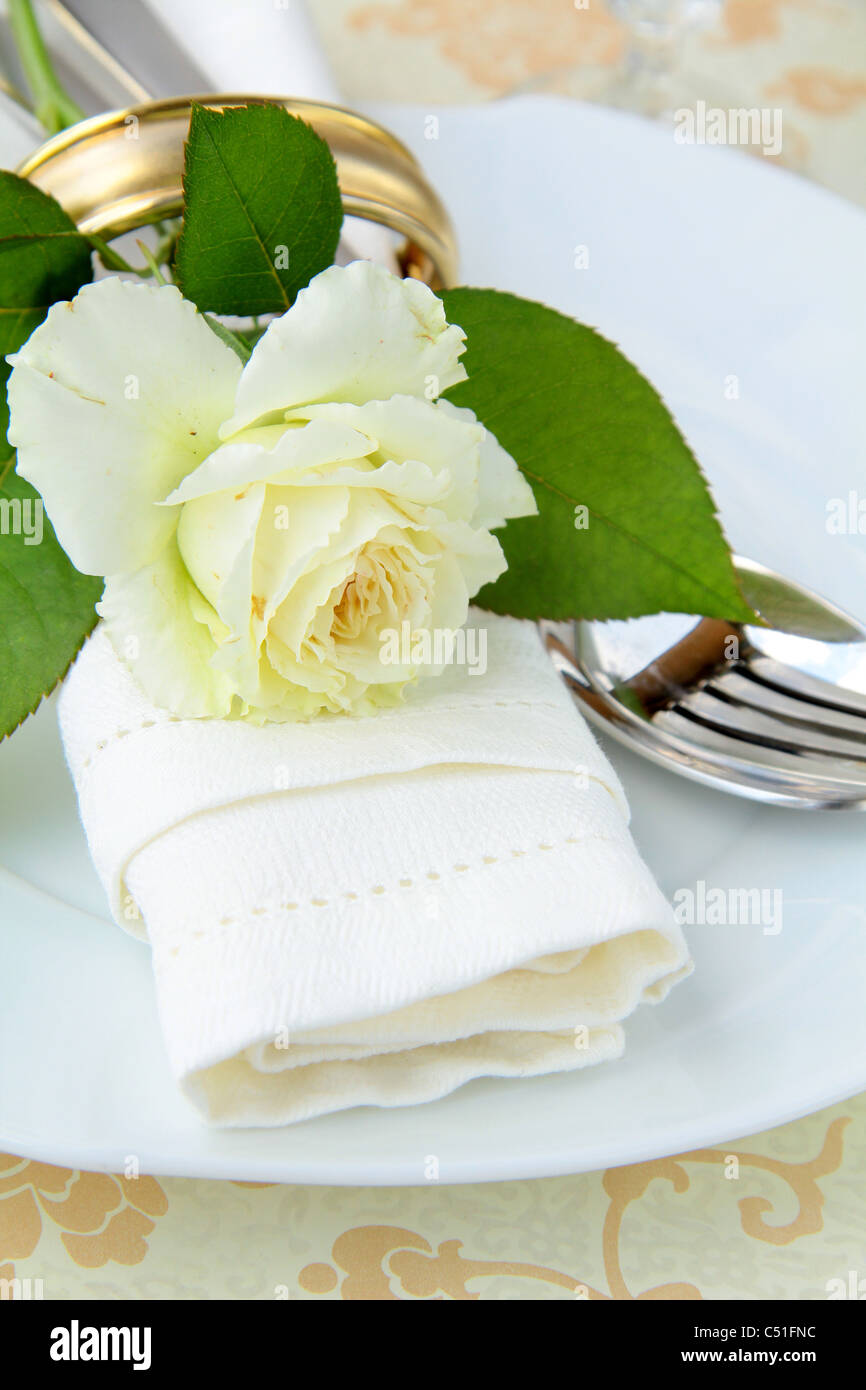 wedding table setting with a white rose Stock Photo - Alamy