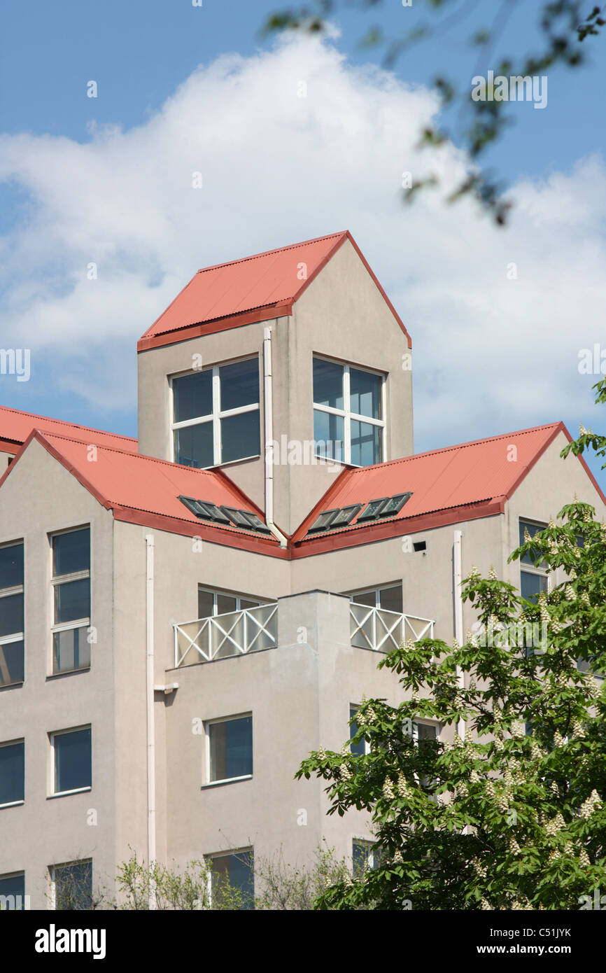 Multi-storey residential building with red roof against the sky Stock ...