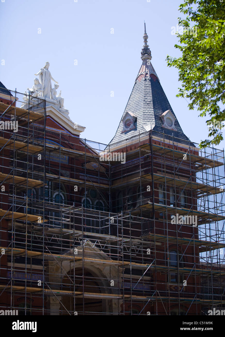 An old building wrapped in scaffolding in preparation for maintenance ...