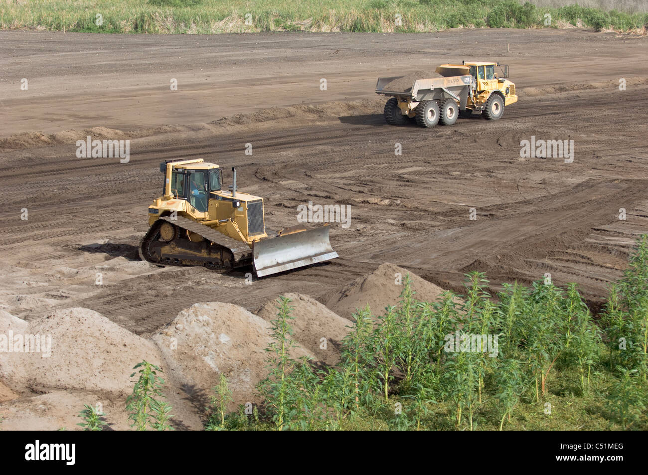 Earth moving construction equipment moving dirt Stock Photo - Alamy