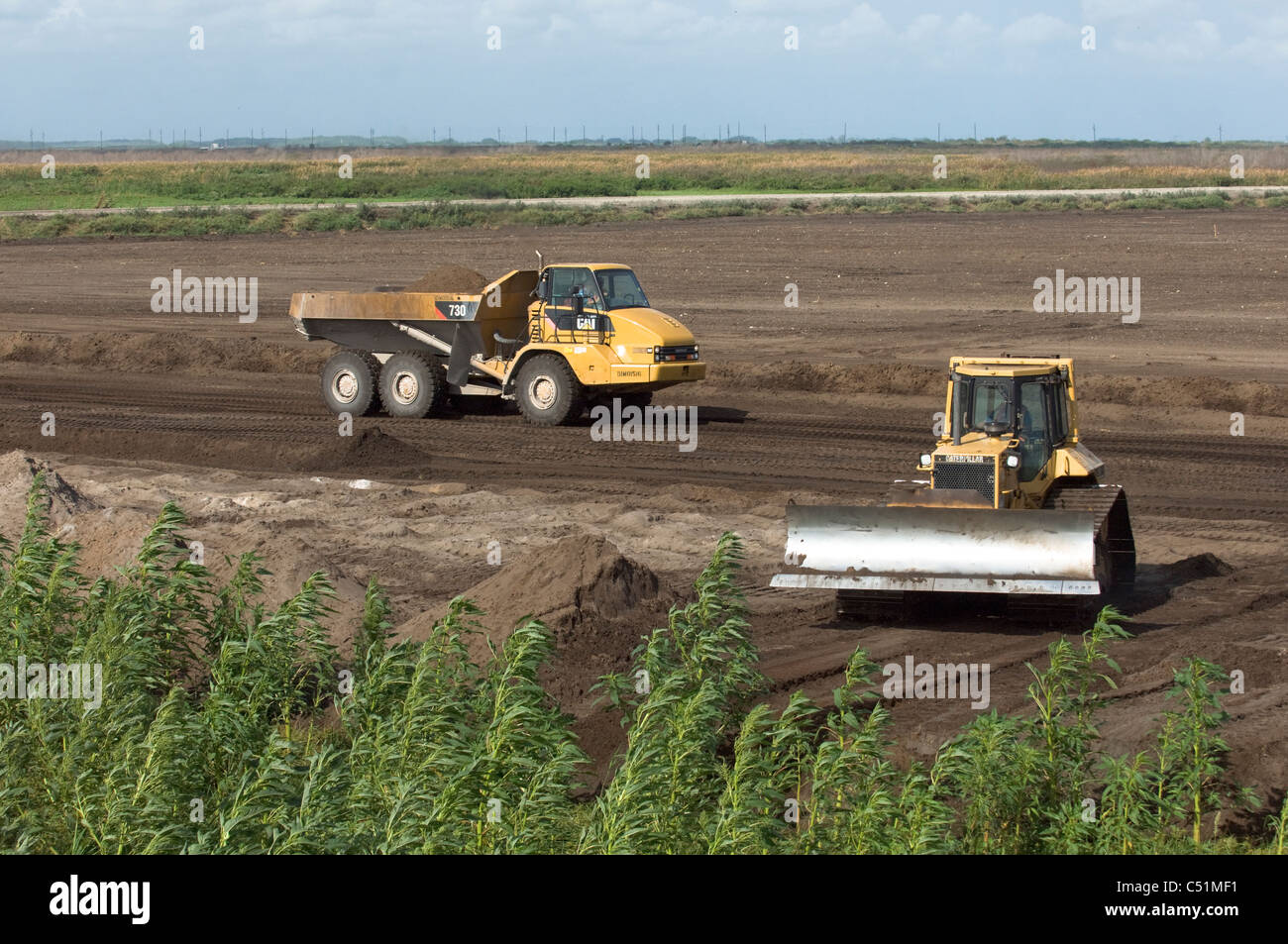 Earth moving construction equipment moving dirt Stock Photo - Alamy