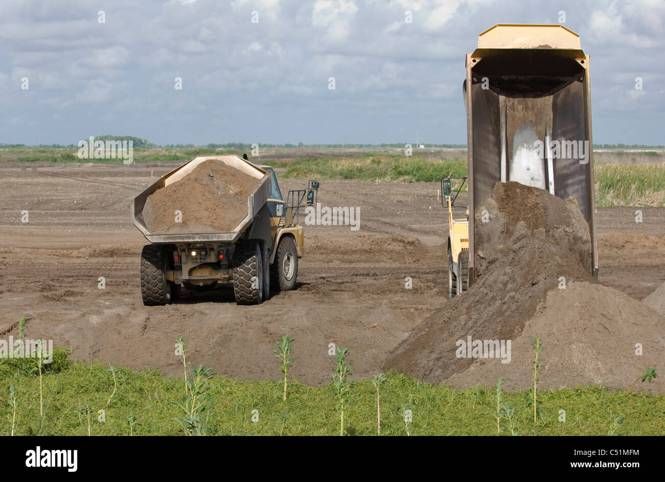 Earth moving construction equipment moving dirt Stock Photo - Alamy
