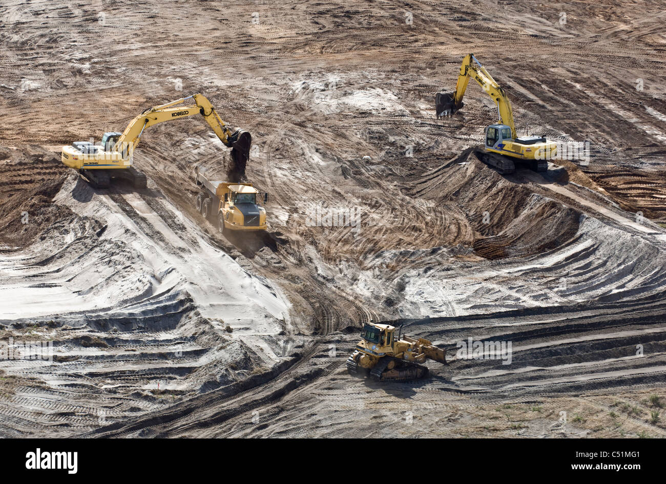Earth moving construction equipment moving dirt Stock Photo - Alamy