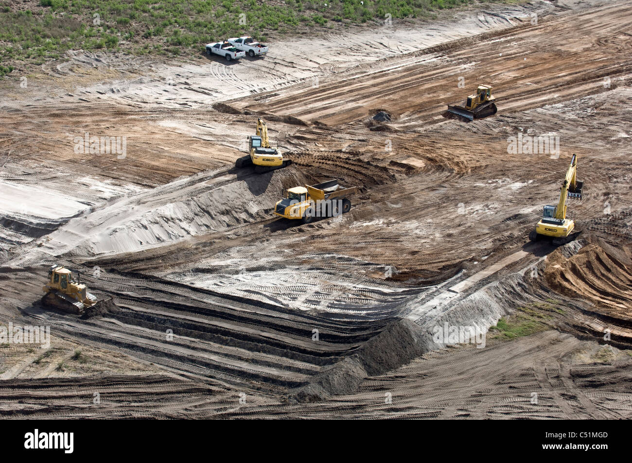 Earth moving construction equipment moving dirt Stock Photo - Alamy