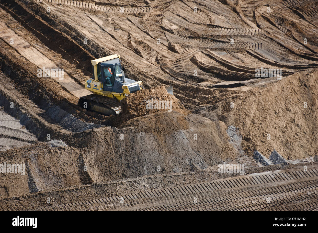 Earth moving construction equipment moving dirt Stock Photo - Alamy