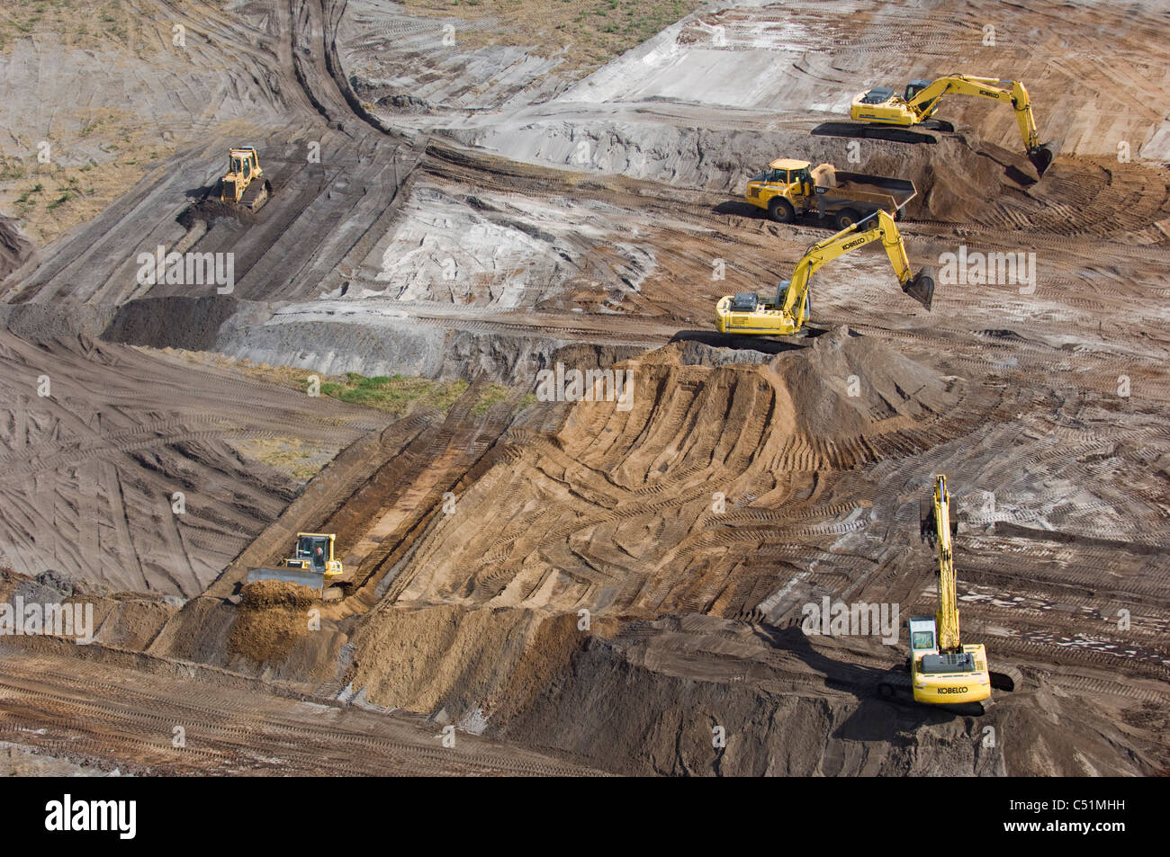 Earth moving construction equipment moving dirt Stock Photo - Alamy